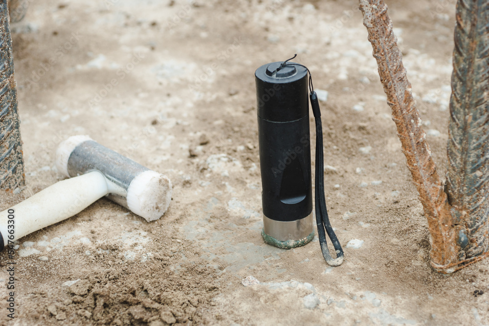 Construction works. Seismic test on concrete pile. Engineer using the ...