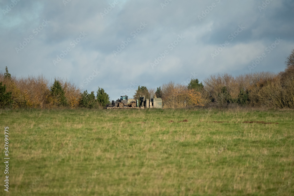 British army MAN HX77 8x8 logistics truck with armed rooftop soldier in ...
