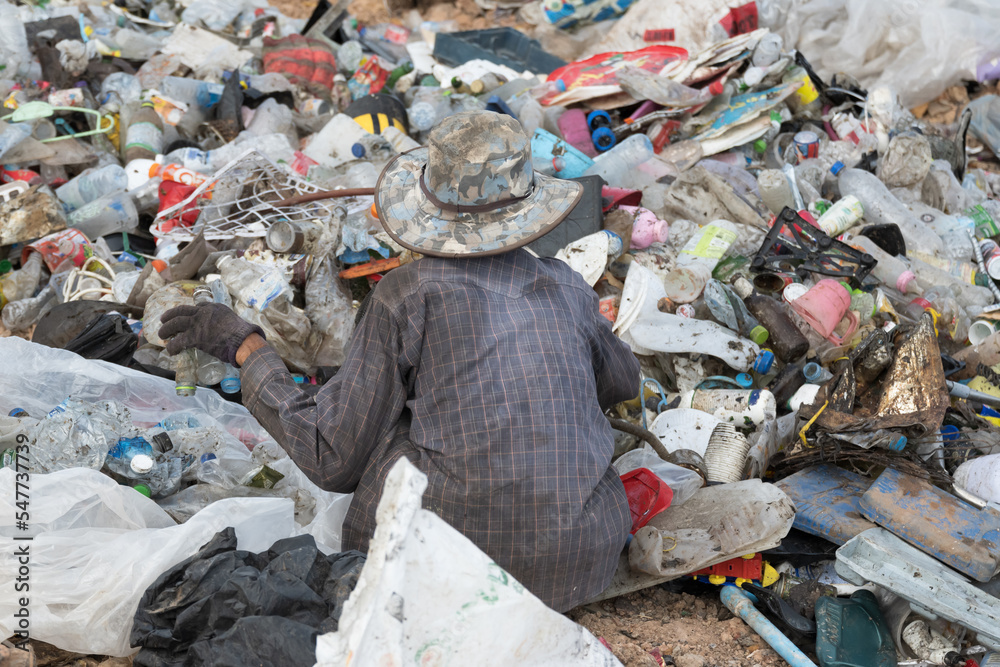 Workers hands sorting garbage for recycling.View of garbage field in ...