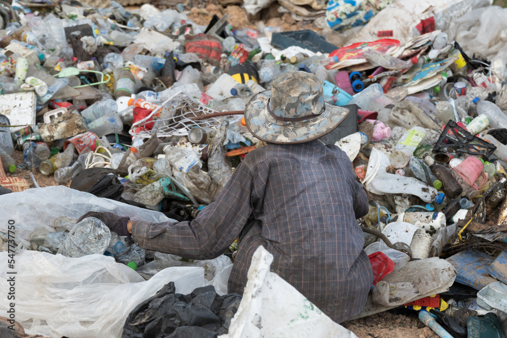 Workers hands sorting garbage for recycling.View of garbage field in ...