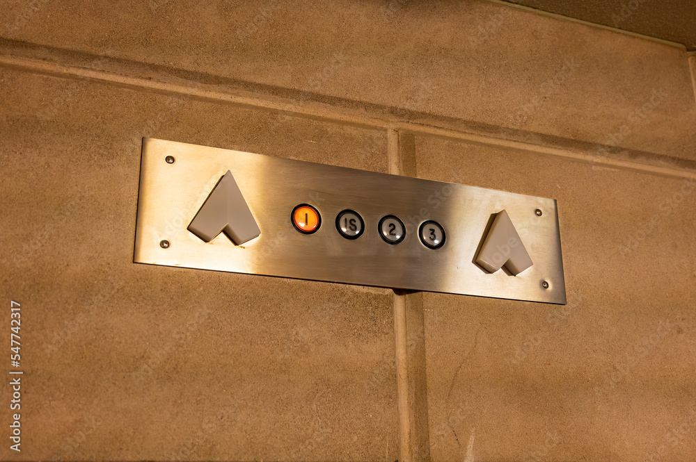 Elevator panel communicating direction and floor of active elevator car ...