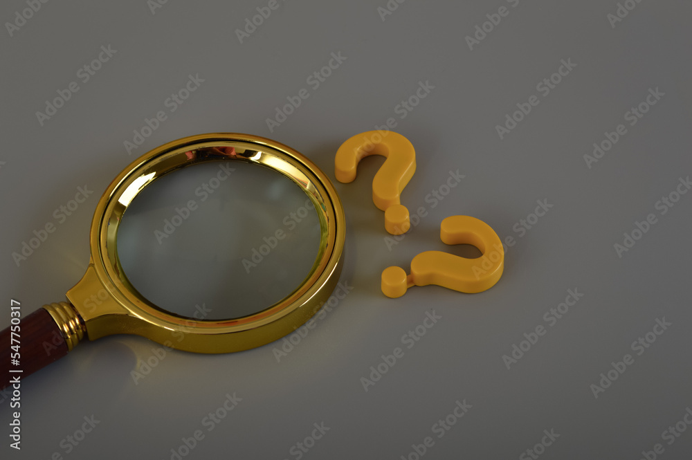 Magnifying glass and question mark symbols isolated on a grey ...