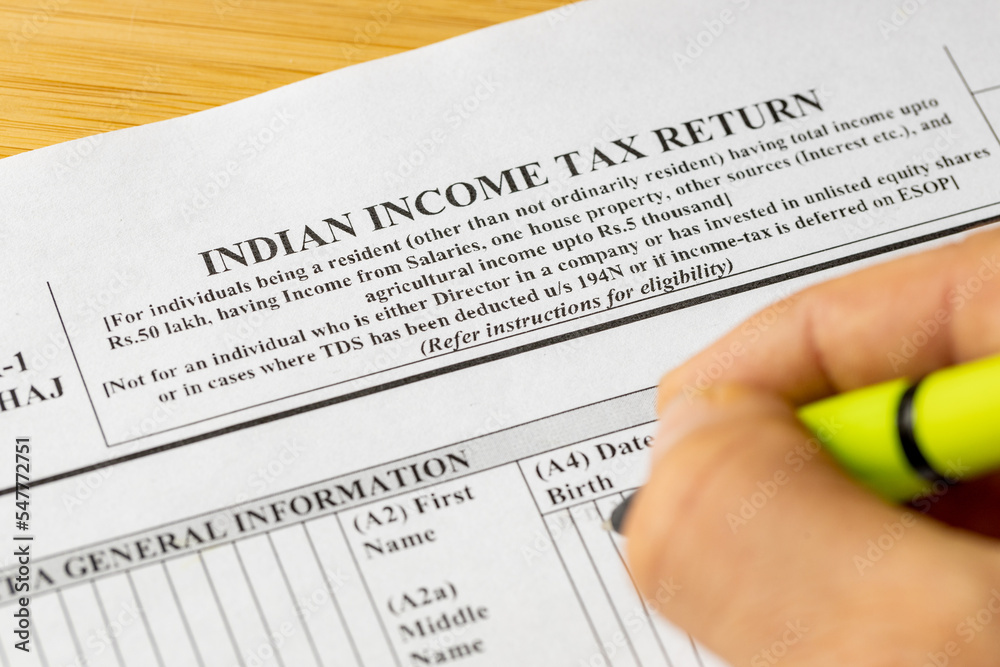 India income tax return, ITR1 form and hand with pen of person filling ...