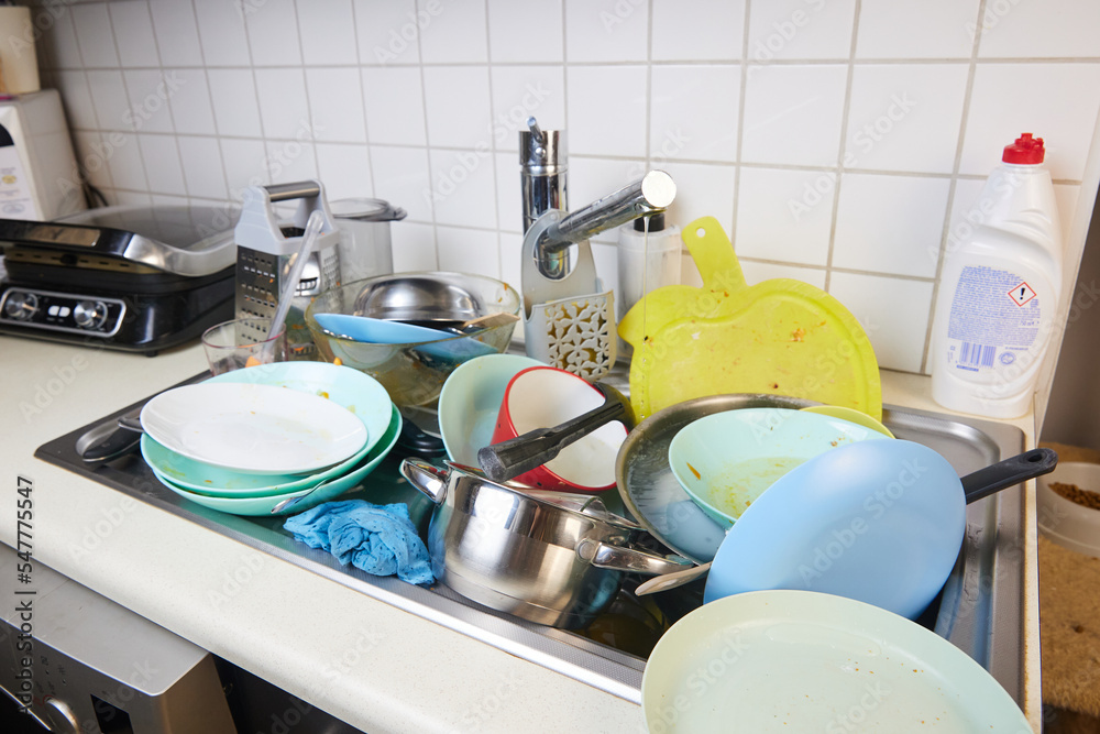 There is a lot of dirty dishes in the kitchen sink. Dirty dishes and ...