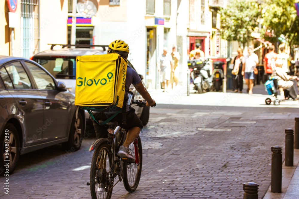 Madrid, Spain. June 1, 2022. Glovo courier. A cyclist delivery man with ...