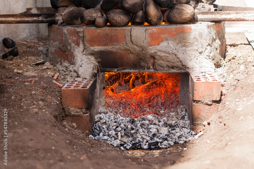 Picture of a pachamanca oven. Traditional peruvian cooking process ...