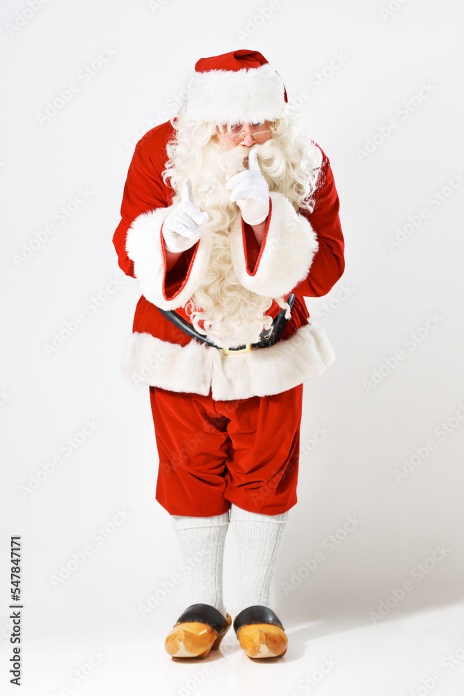Christmas, santa claus and man in studio for secret, surprise and ...