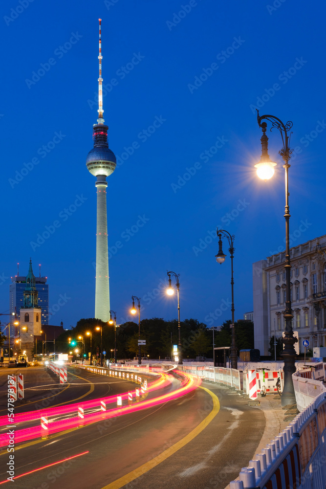 Germany, Berlin, Vehicle light trails stretching along illuminated ...