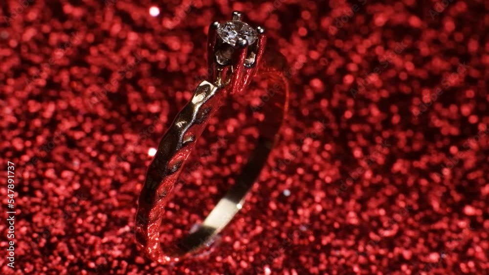 Beautiful shiny golden engagement ring with big gem diamond on glitter ...