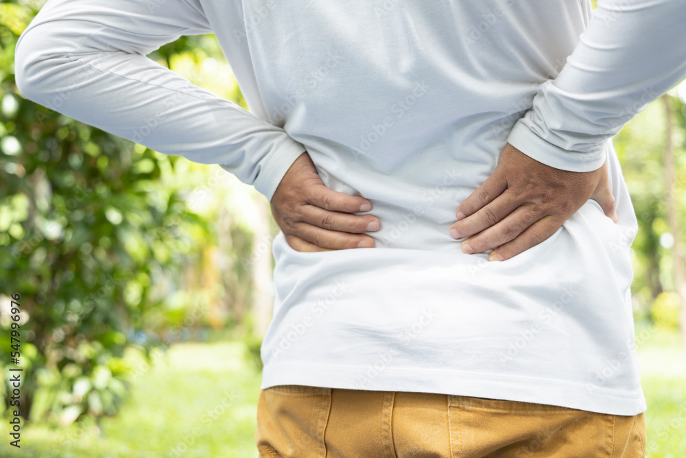 old Asian senior man suffering from lower back pain, herniated disc ...