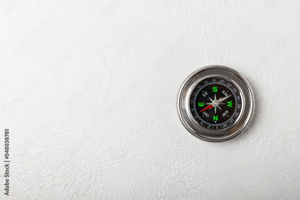 Classic round compass on a white texture background. Symbol of tourism ...