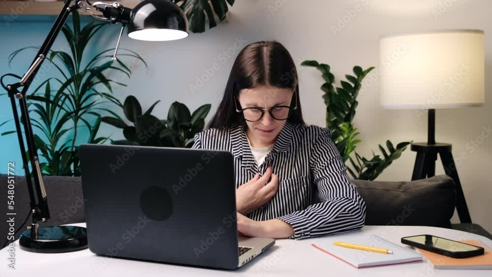 Chest pain concept. Stressed upset young business woman in glasses ...