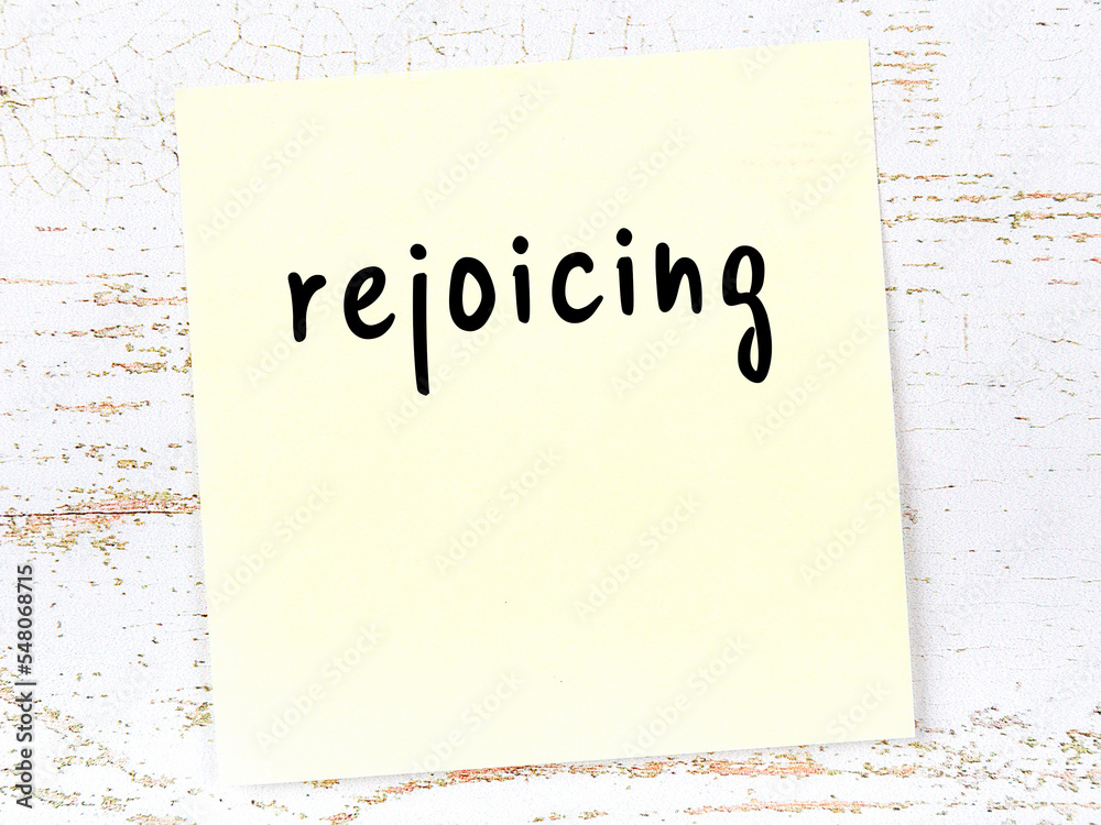 Yellow sheet of paper with word rejoicing. Reminder concept Stock ...