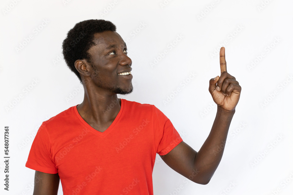 Joyful man pointing up. Young African American male model smiling ...