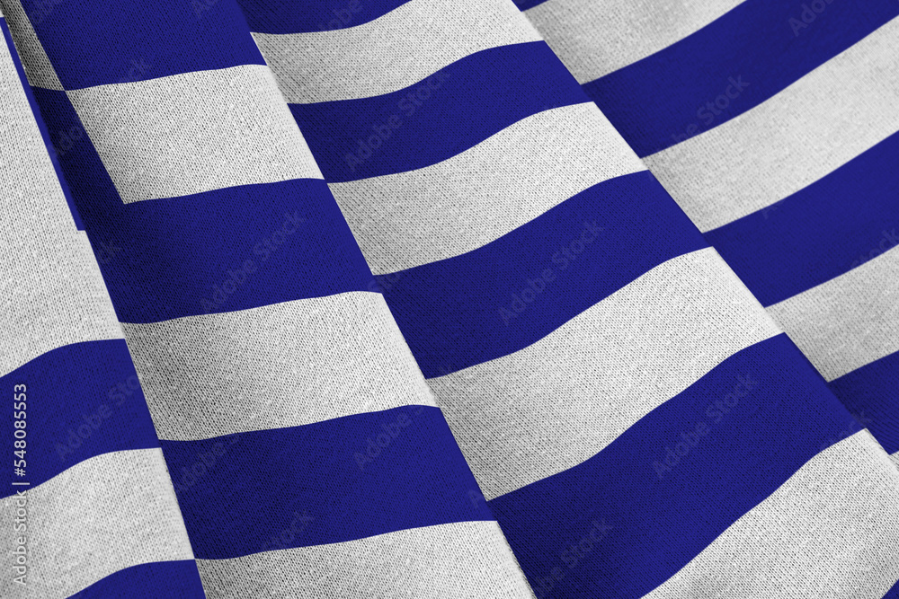 Greece flag with big folds waving close up under the studio light ...