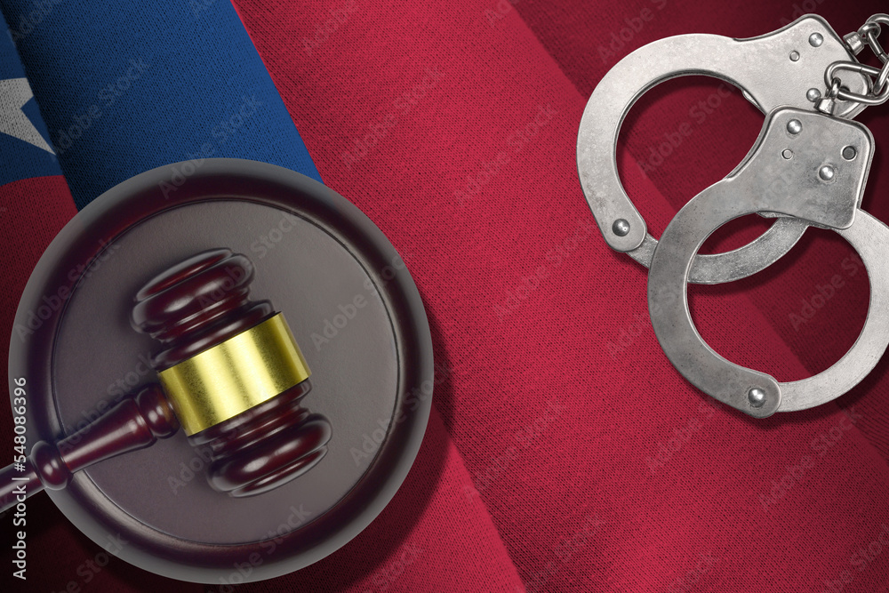 Samoa flag with judge mallet and handcuffs in dark room. Concept of ...