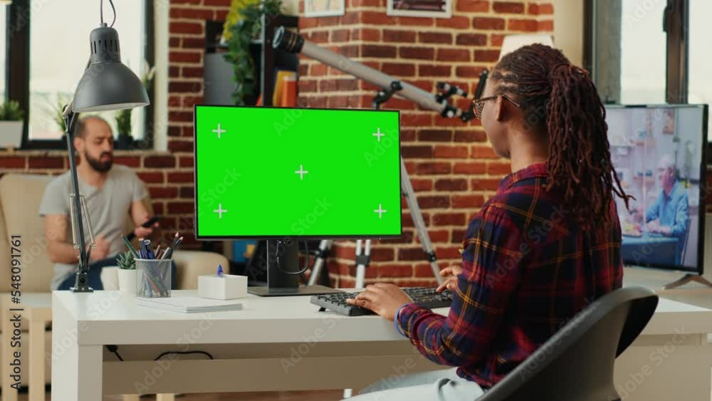 African american freelancer watching computer with greenscreen template ...