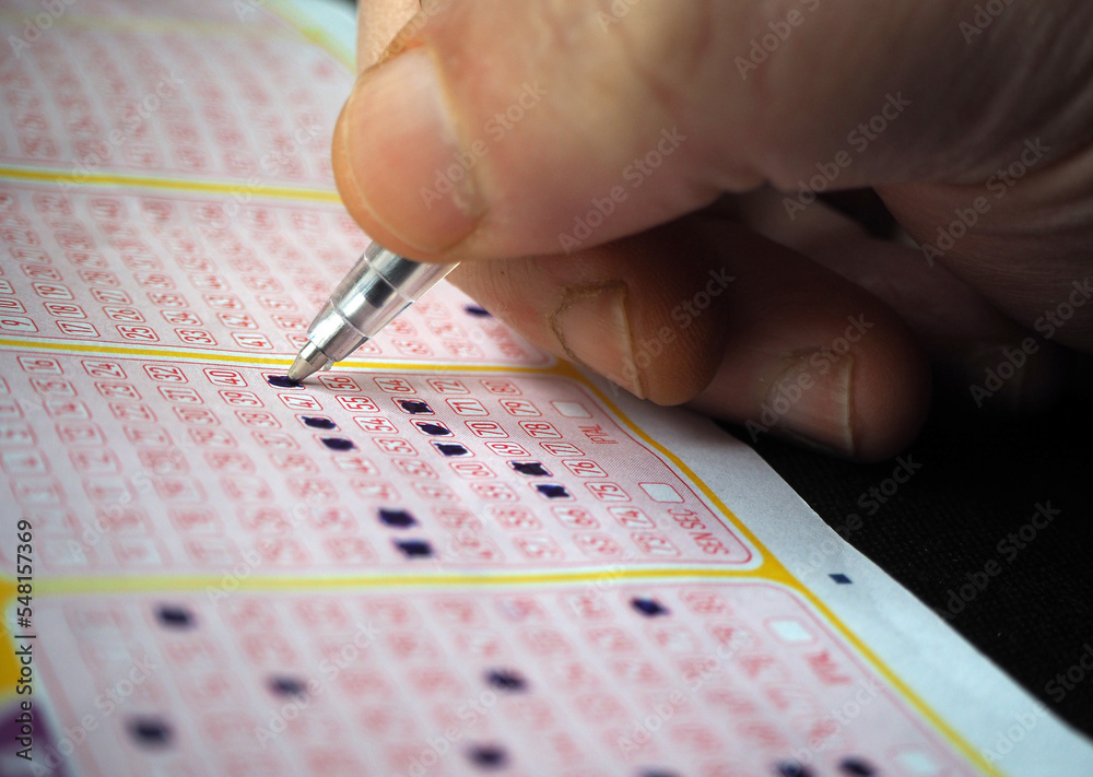 Hand that fill out the lottery paper. Tick off the boxes on the lotto ...