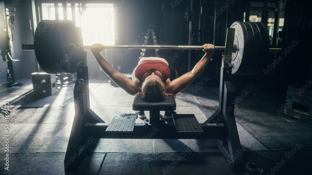 A Determined Female Powerlifter Finishing Her Workout Day in a Hardcore ...