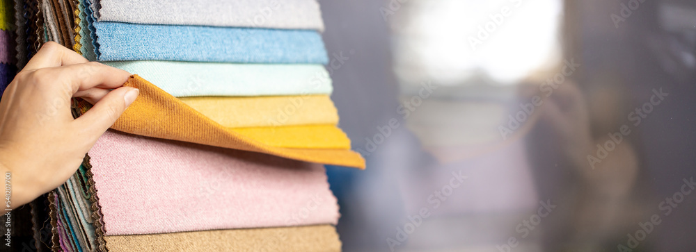Fabric swatches in different colors are stacked for selection. The ...