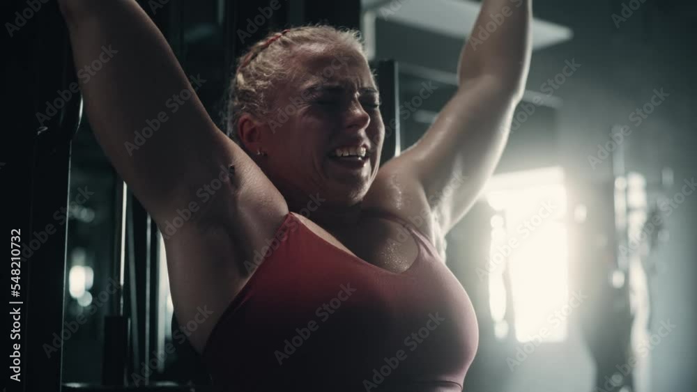 A Persistent Female Bodybuilder Enduring the Workout Pain of Exercising ...