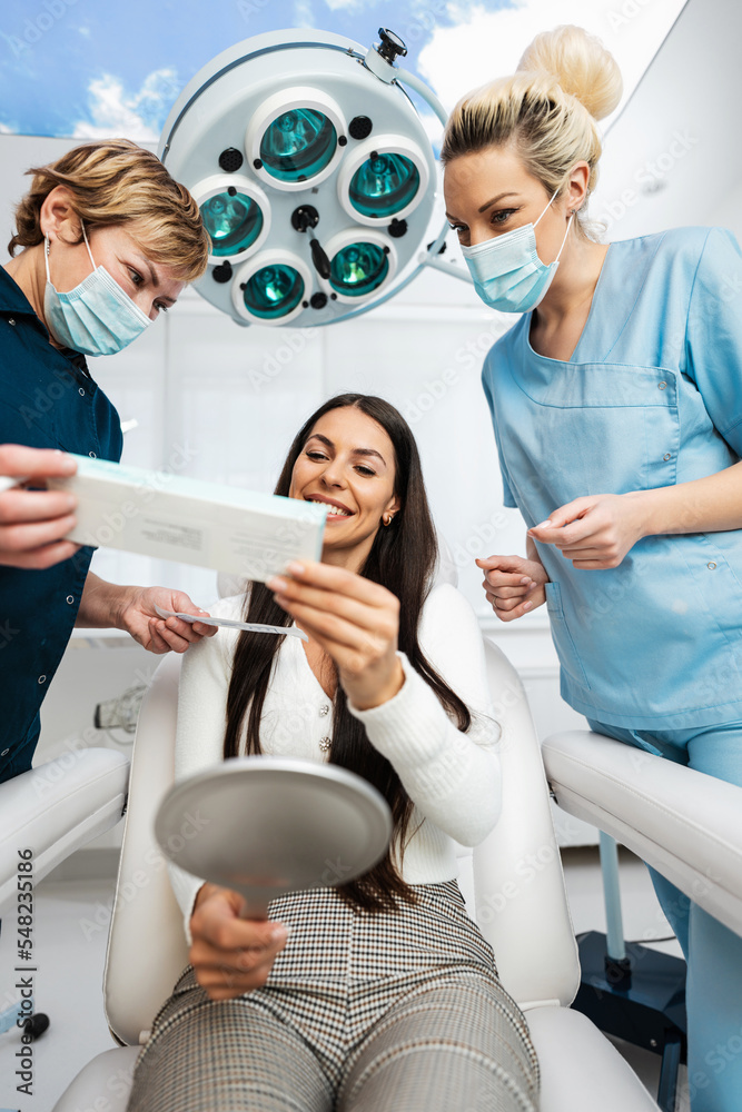 Beautiful and happy brunette woman at beauty medical clinic. She is ...