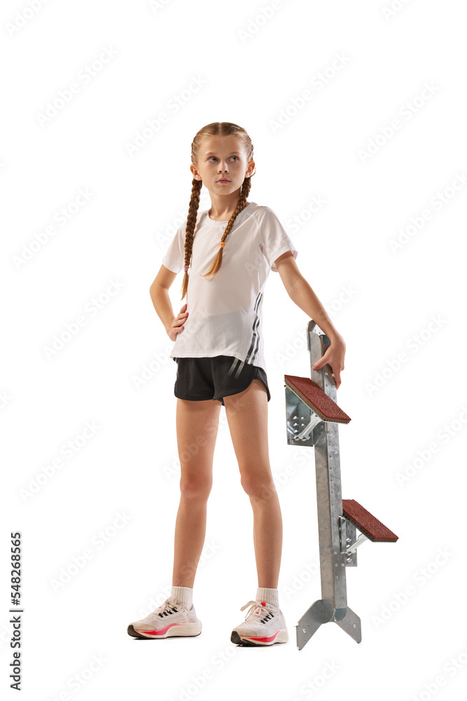 Portrait of little girl, beginner athlete in sportswear posing with ...