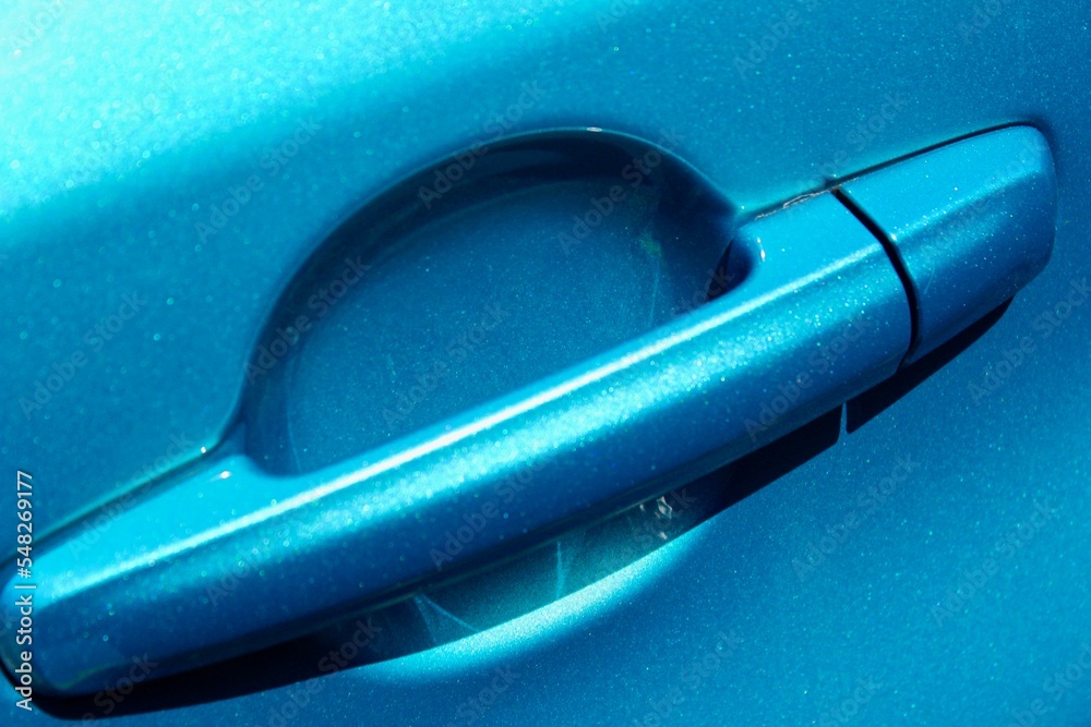 Blue car door handle gleams in sunlight, inviting exploration. Every ...