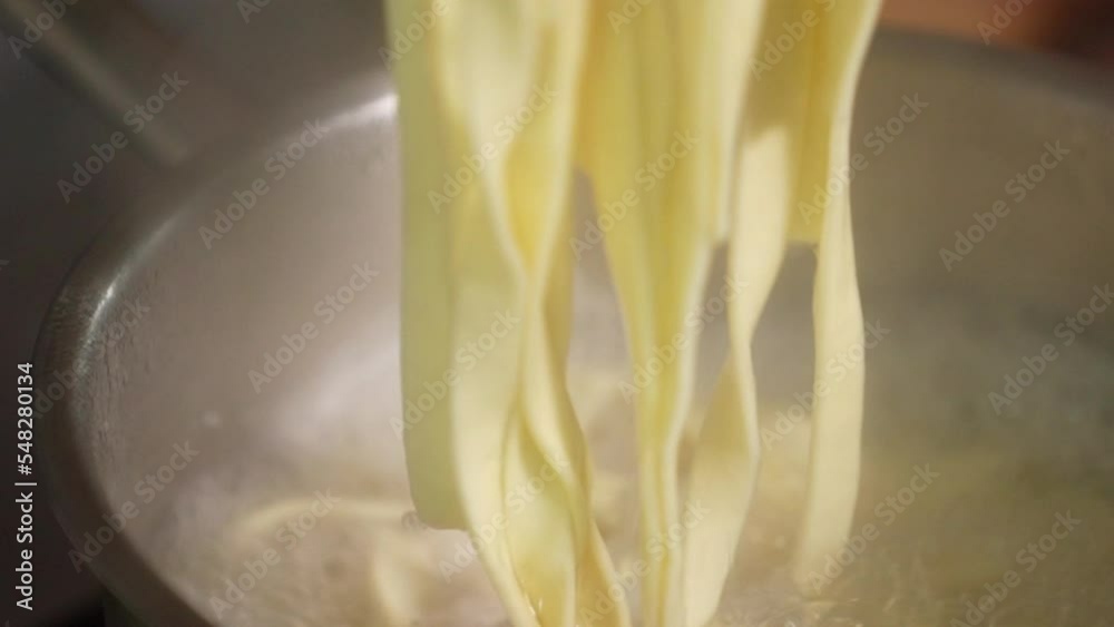 The process of making pasta. The cook takes out the finished pasta from ...