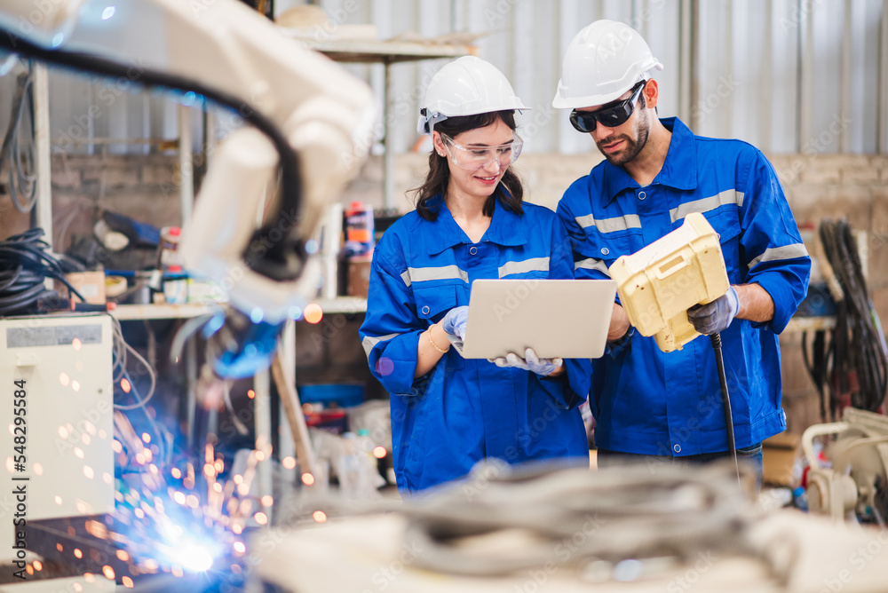 Robotic engineer male and female using laptop for workinging and ...