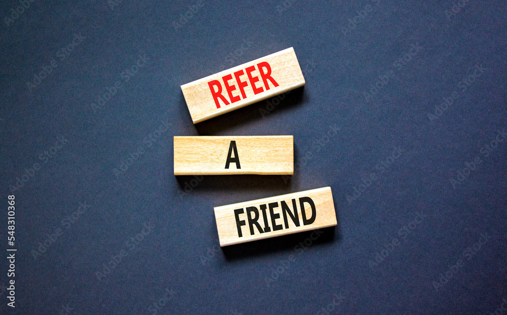 Refer a friend symbol. Concept words Refer a friend on wooden blocks on ...