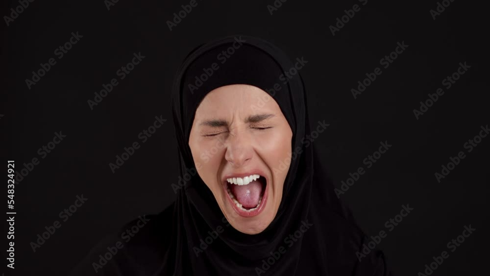 Emotional breakdown. Young angry muslim woman in traditional hijab ...