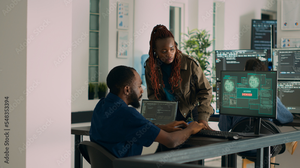 Team of coders writing data and encountering system crash, dealing with security breach warning ...