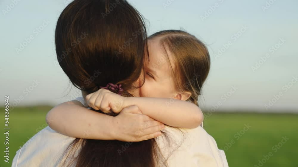 Mom, child are hugging in summer park. Happy childrens family, mother ...