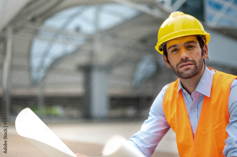Caucasian man engineer wearing orange vest and big hard hat, and the ...