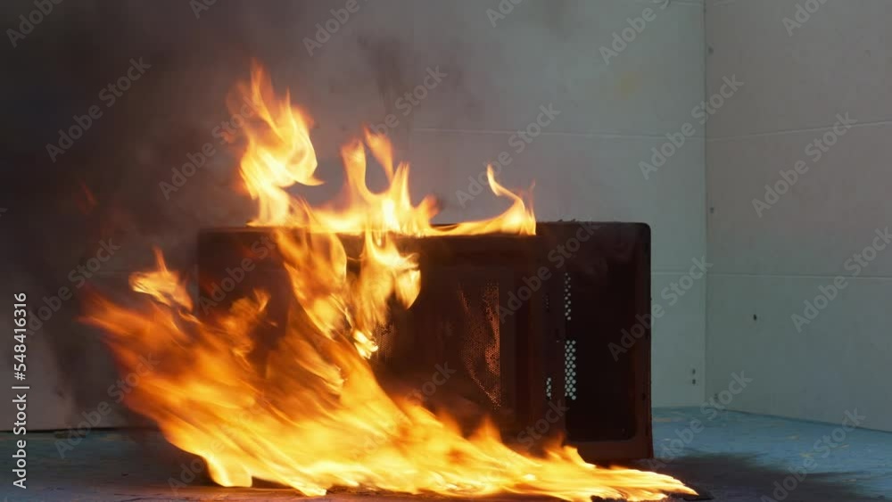 microwave oven on fire. the concept of fire in the kitchen and ...