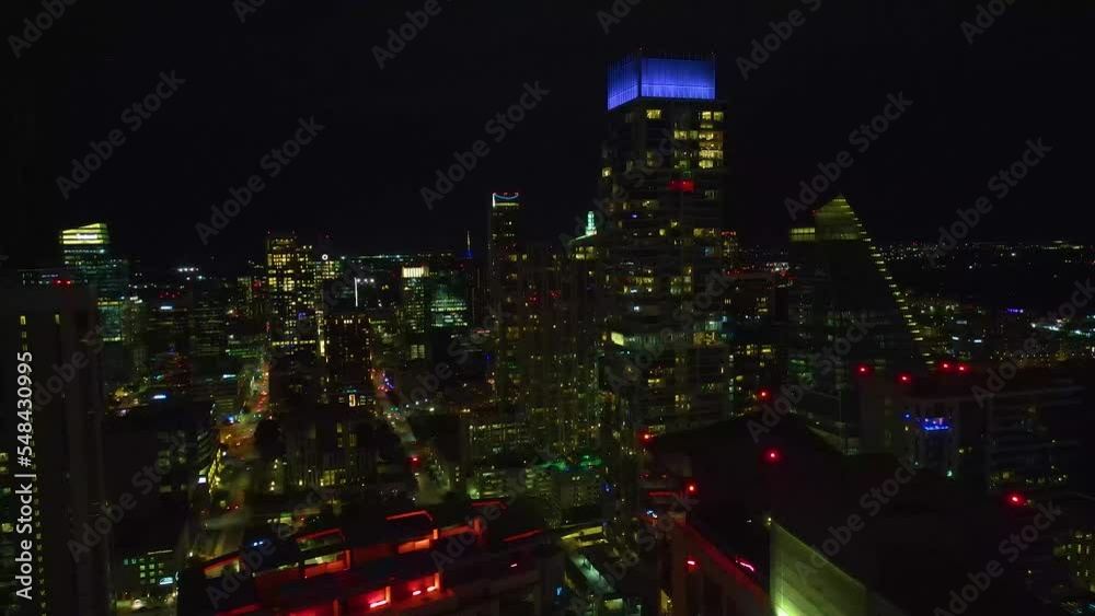 Austin Texas skyline at night. Drone footage looks up at apartment ...