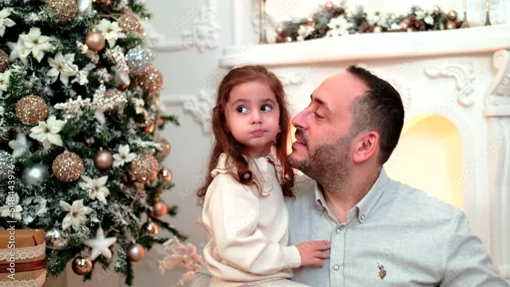 Portrait of a father and daughter chilling in front of a fireplace and ...