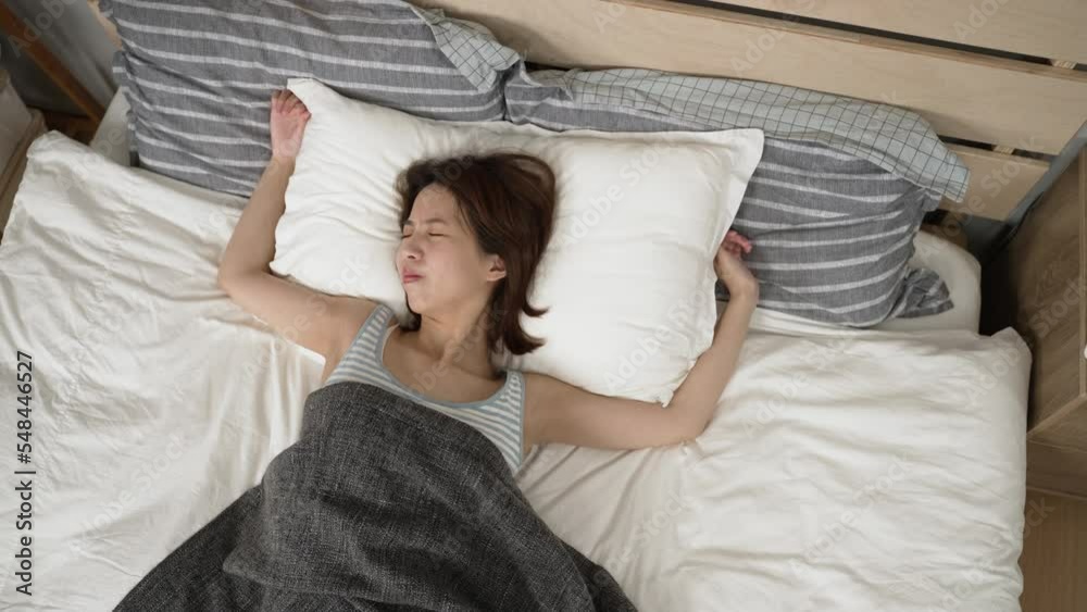 top view attractive carefree asian woman in comfy pajamas looking above ...