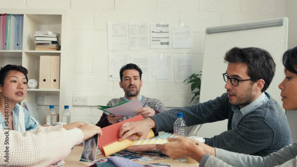 Creative, fashion and team planning a project with paperwork, color ...