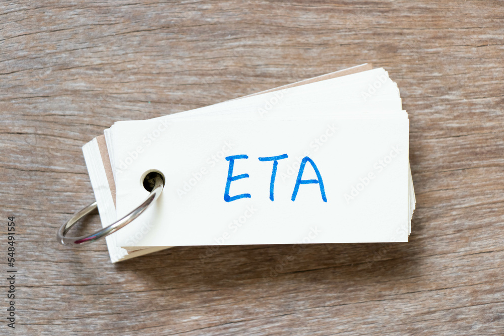 Flash card with handwriting in word ETA (abbreviation of estimated time ...