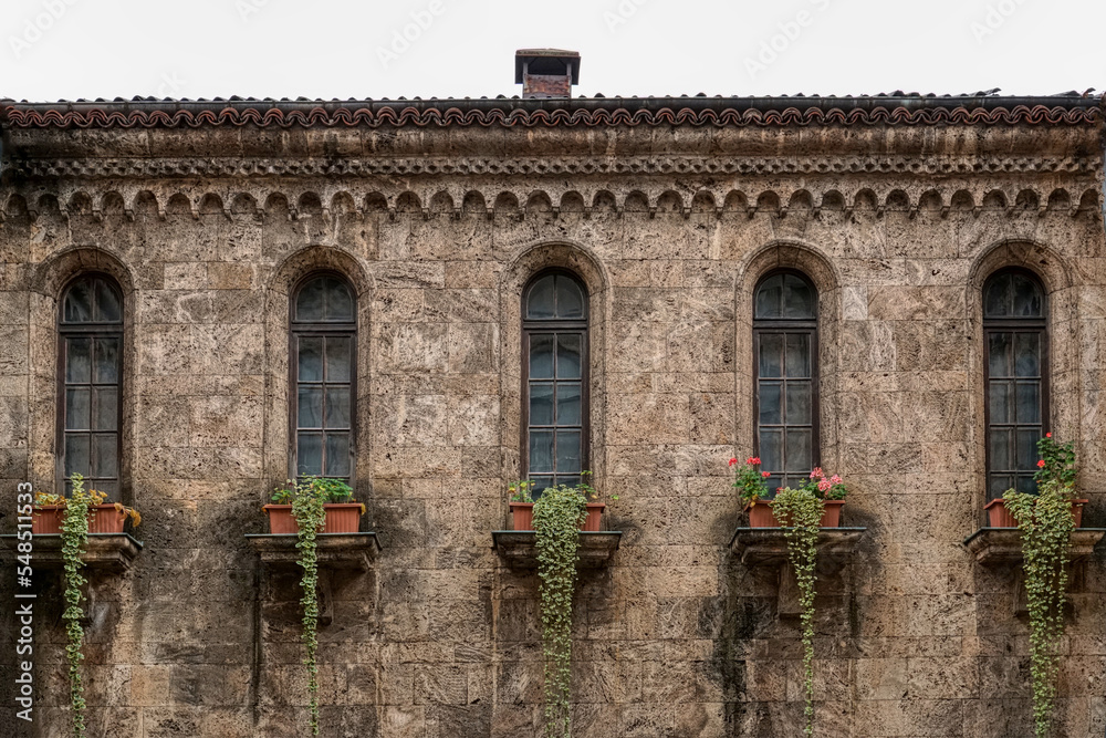 Classic stone windows with flowers Archaeological Museum facade Veliko ...
