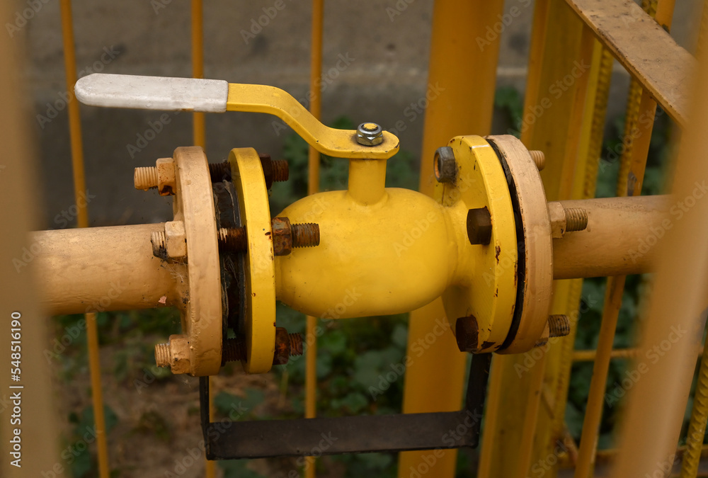 yellow gas pipe with a crane goes along the facade of a new multi ...