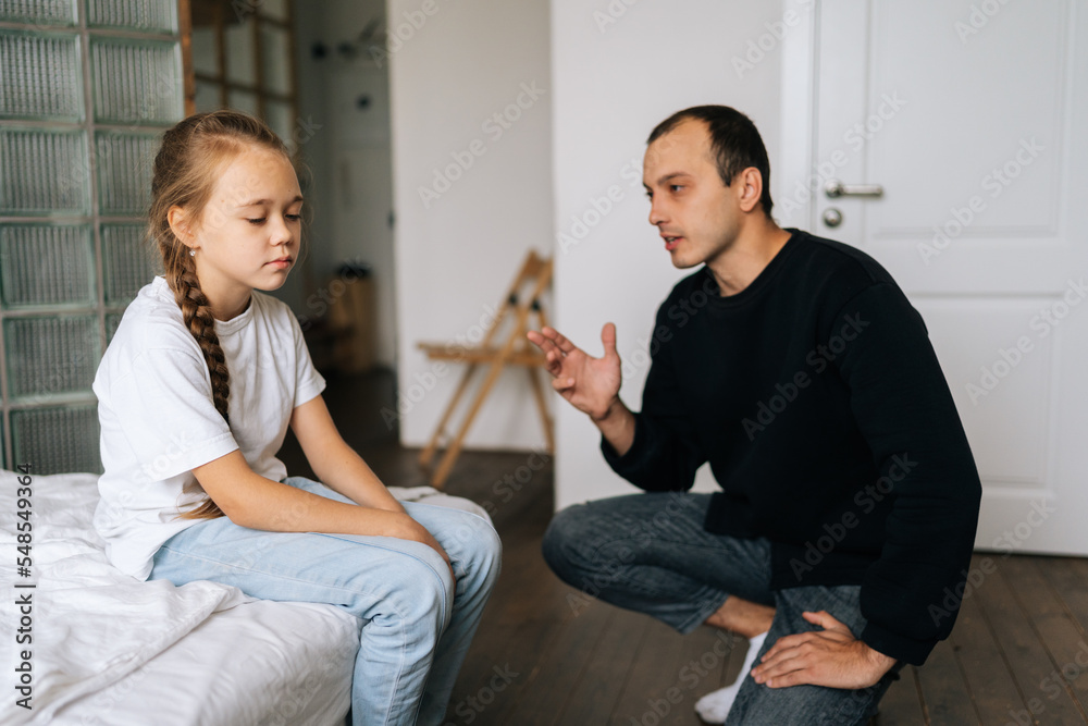 Portrait of young father having serious conversation with naughty ...