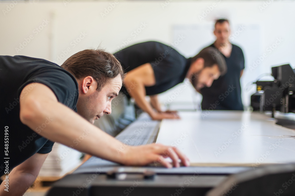 Professional worker printmaker technician operator works in printing ...