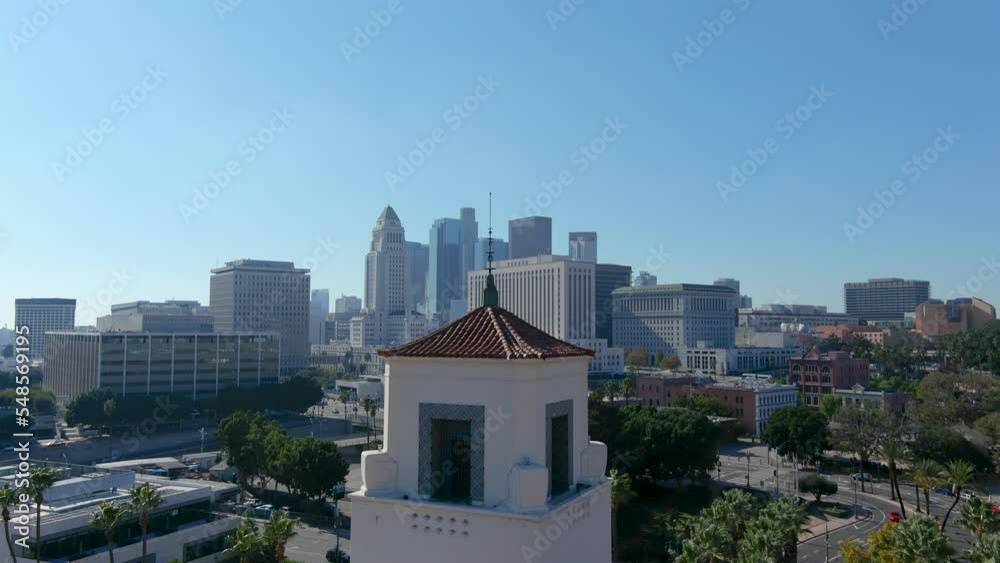 ascending aerial footage of Los Angeles Union Station with skyscrapers ...