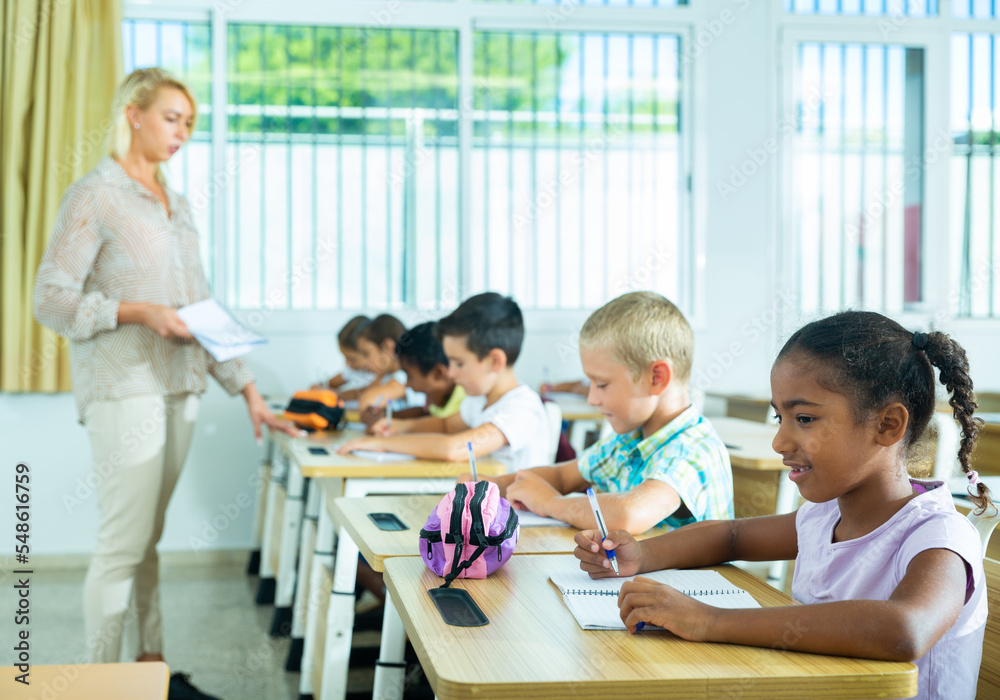 School children writing test, smart young people studying at primary ...