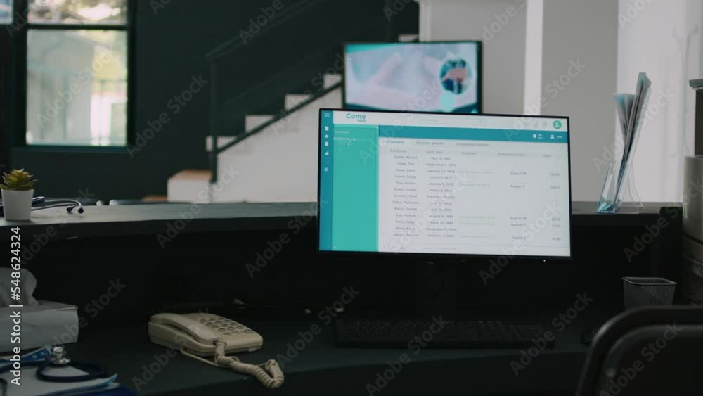Hospital reception counter with computer showing appointments list ...