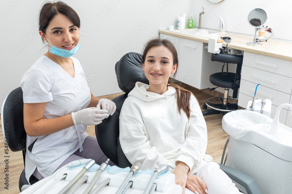 Orthodontist checking brackets on female teeth. Concept of stomatology ...