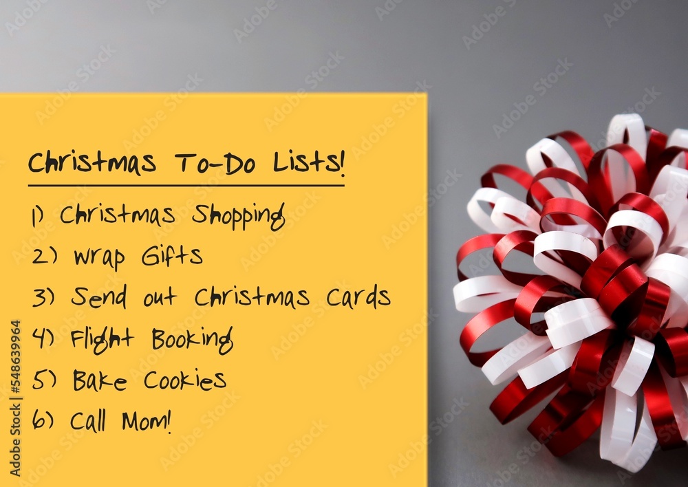 Gift bow and stick note with handwritten text Christmas to-do list with ...